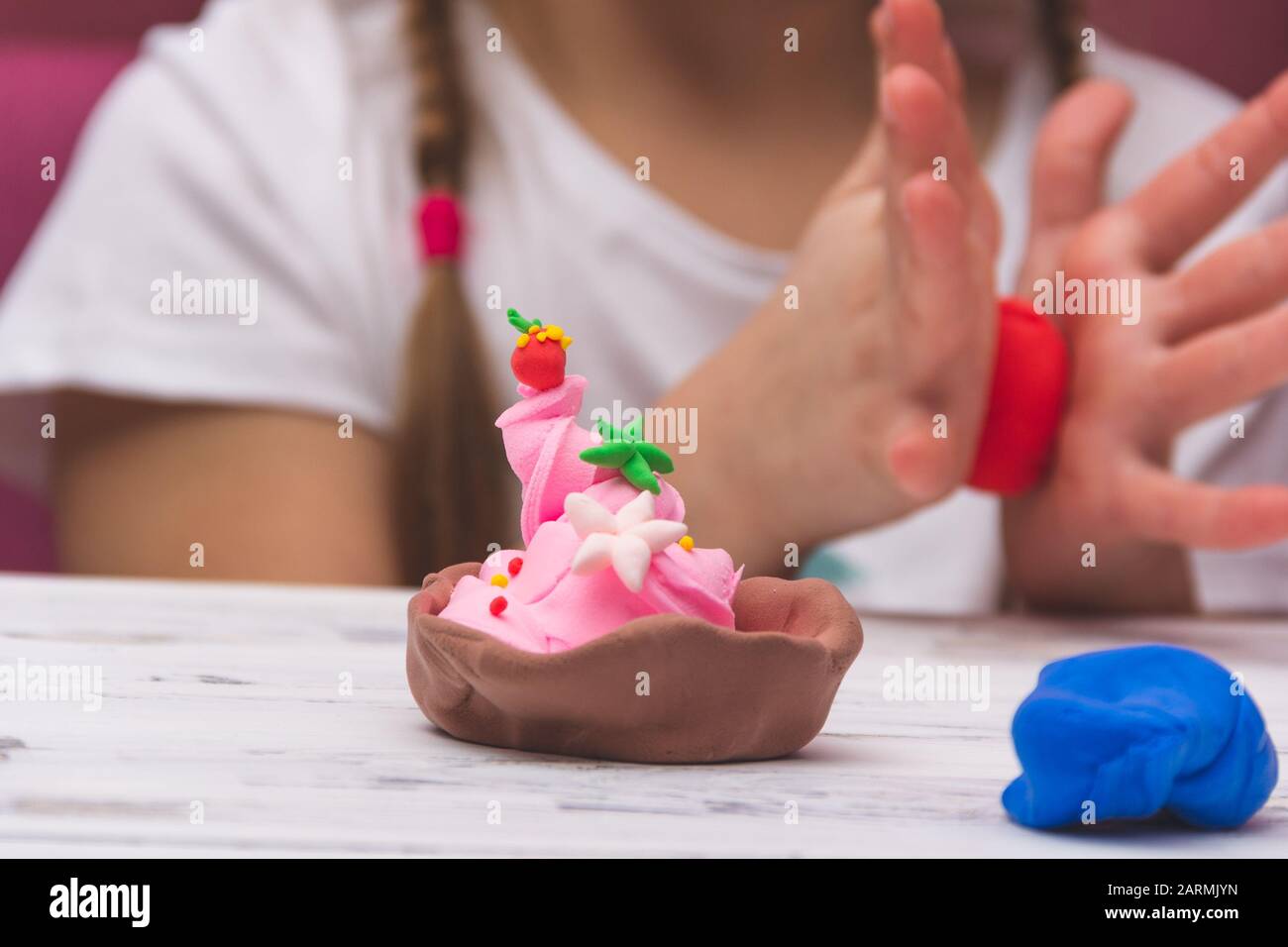Girl playing modeling clay hi-res stock photography and images - Alamy