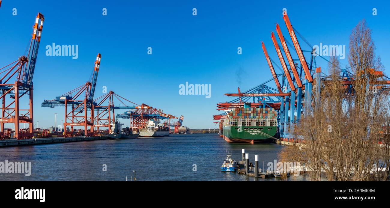 Hamburg container port with some ships loading and cranes transporting ...
