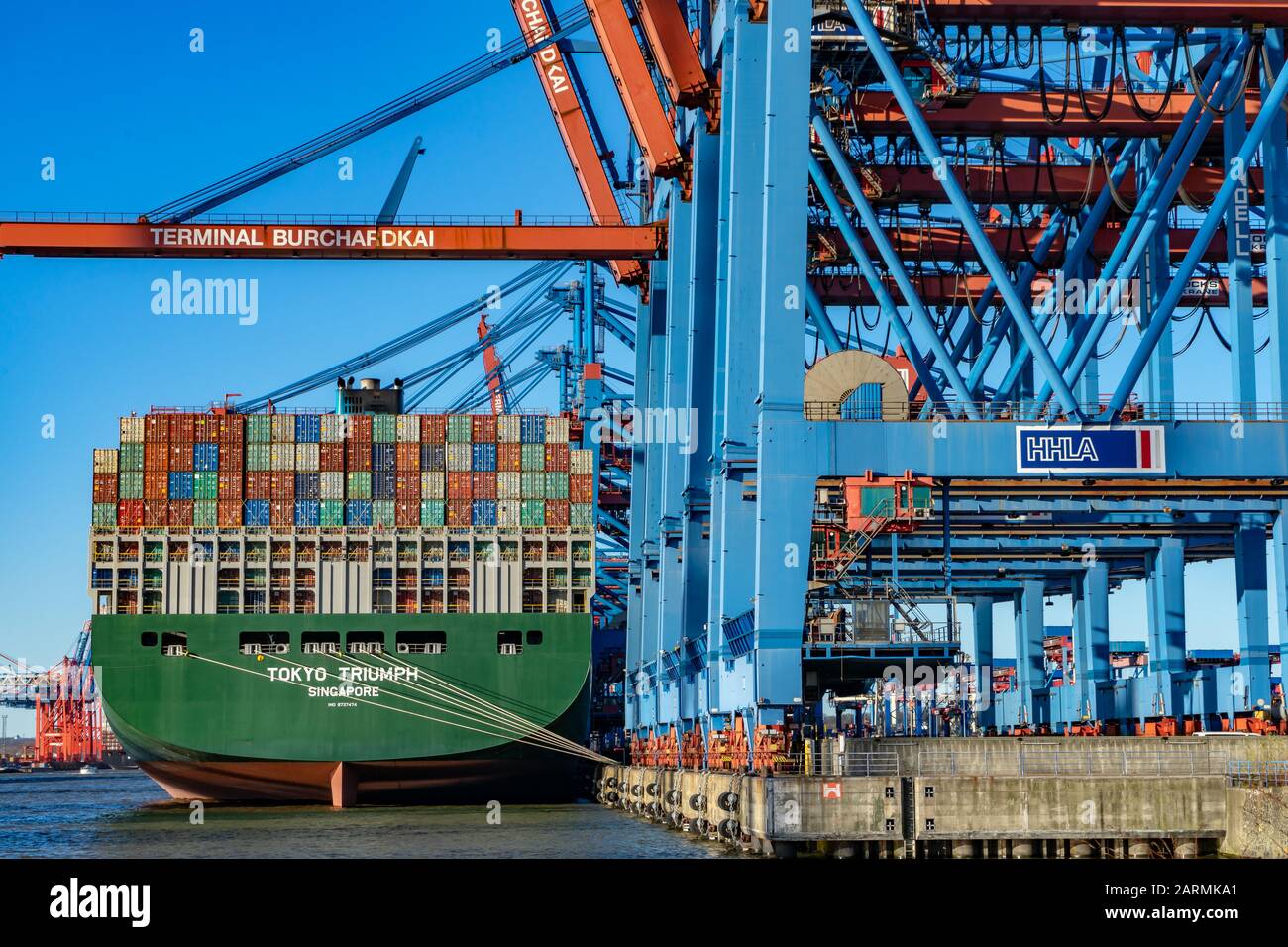 Hamburg container port with some ships loading and cranes transporting ...