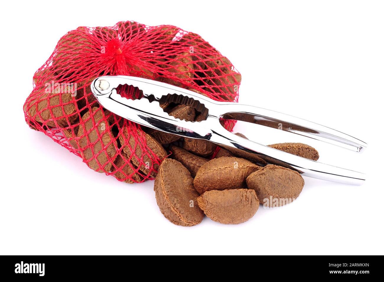 Brazil nuts with nut crackers in red string bag packaging Stock Photo ...