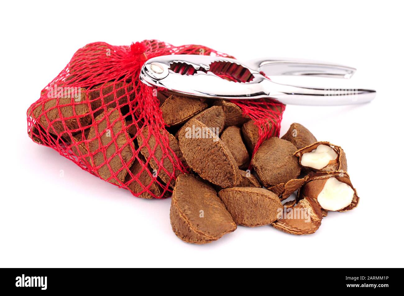 Brazil nuts with nut crackers in red string bag packaging Stock Photo ...
