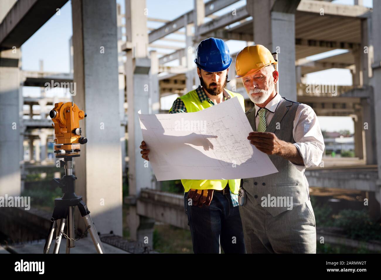 Team of construction engineers, architects working on building site ...