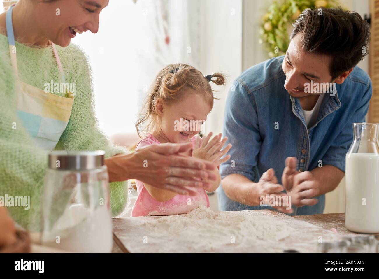 Happy family playing with flour in the kitchen Stock Photo - Alamy
