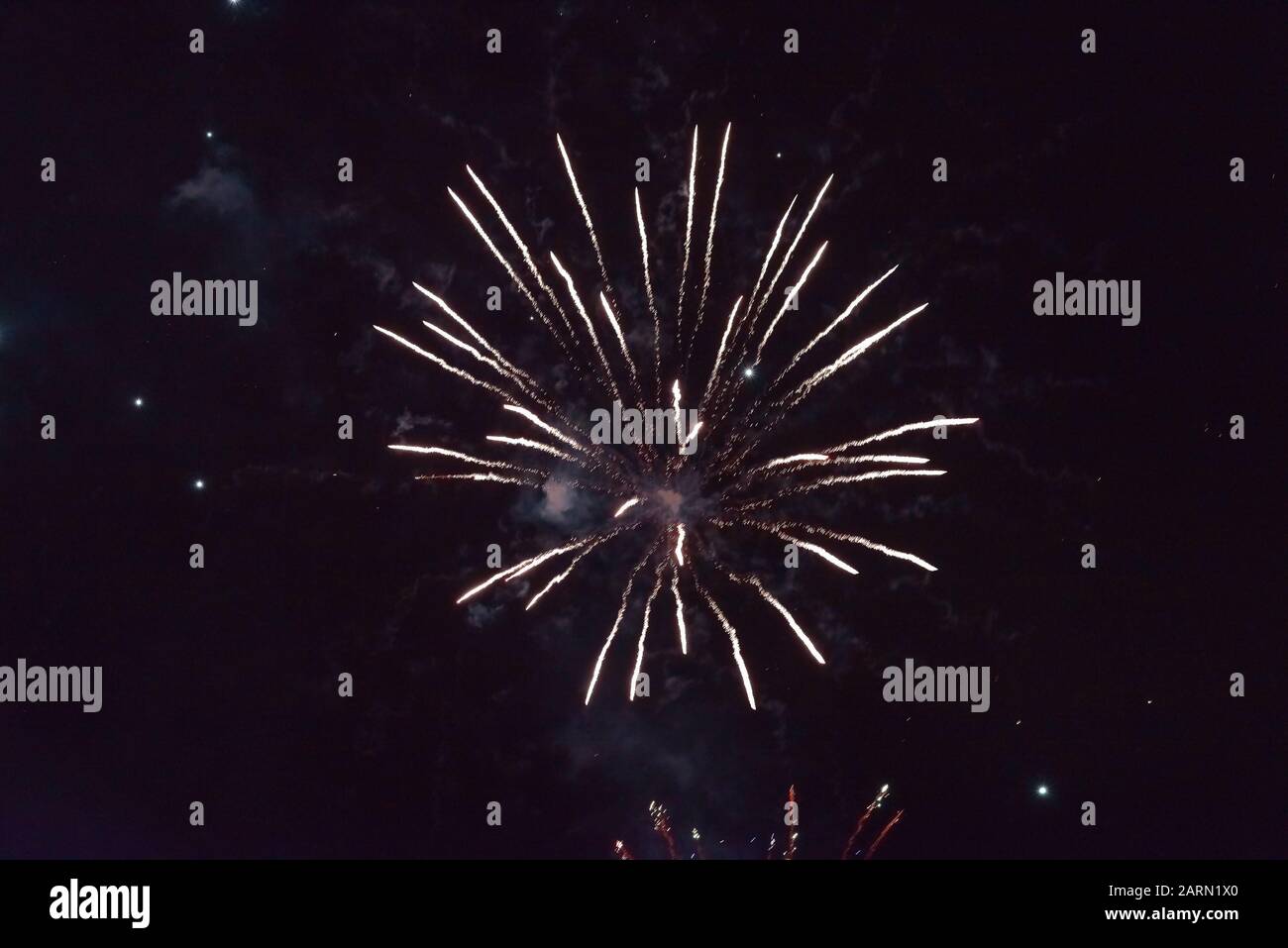A flash of plain white fireworks. In the night sky Stock Photo - Alamy