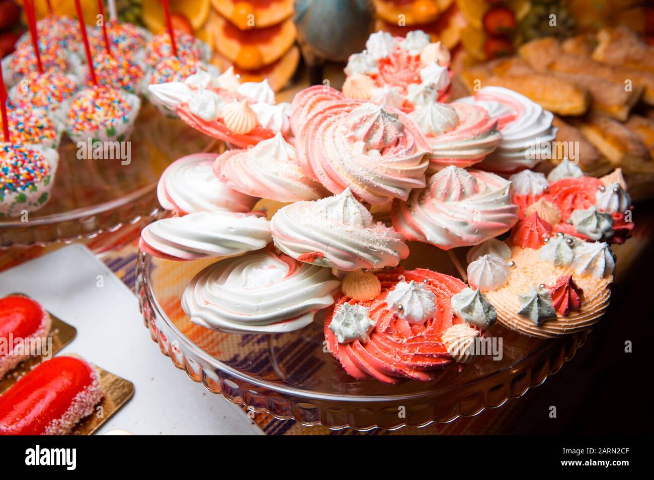 Crispy twisted meringues lie on a plate. Candy bar Stock Photo - Alamy