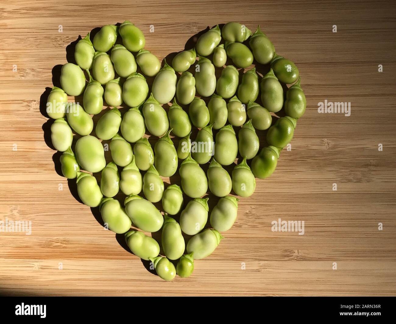 Broad beans in a heart shape Stock Photo - Alamy