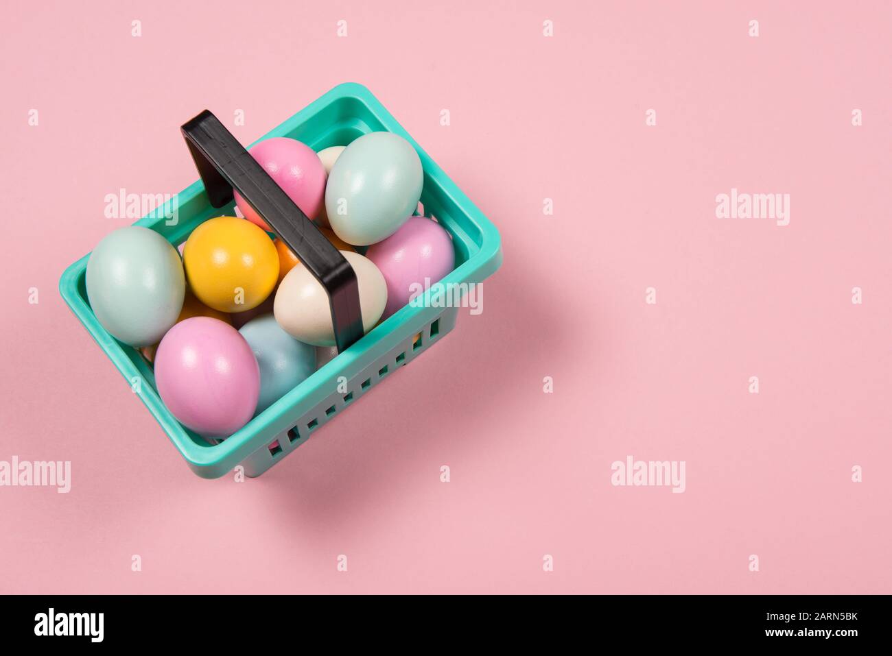 Easter background with pastel colored easter eggs in a shopping basket ...