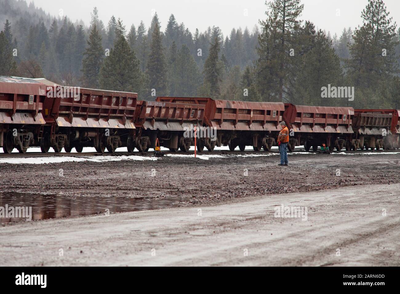 A Burlington Northern BNSF Railroad switchman on the tracks by a line ...