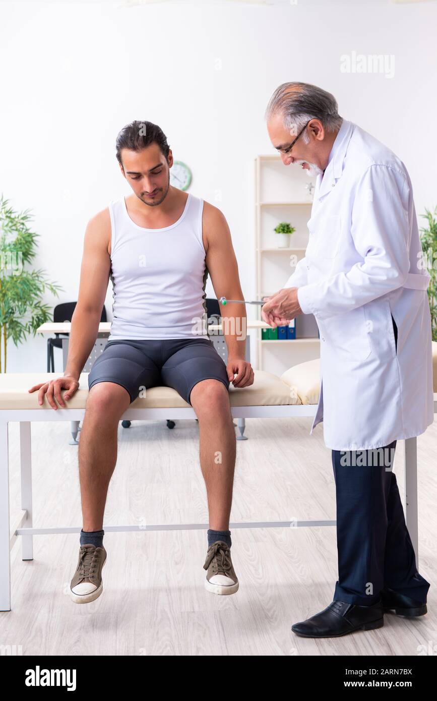 The young male patient visiting experienced doctor Stock Photo - Alamy
