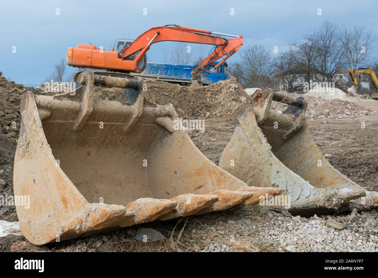 Shovels of excavator machine on construction site Stock Photo - Alamy