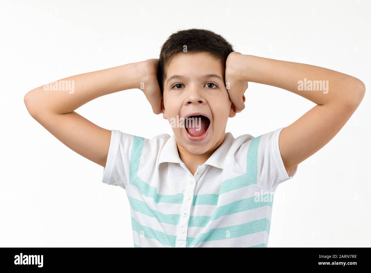 surprised shocked little child boy in t-shirt looking to camera on ...
