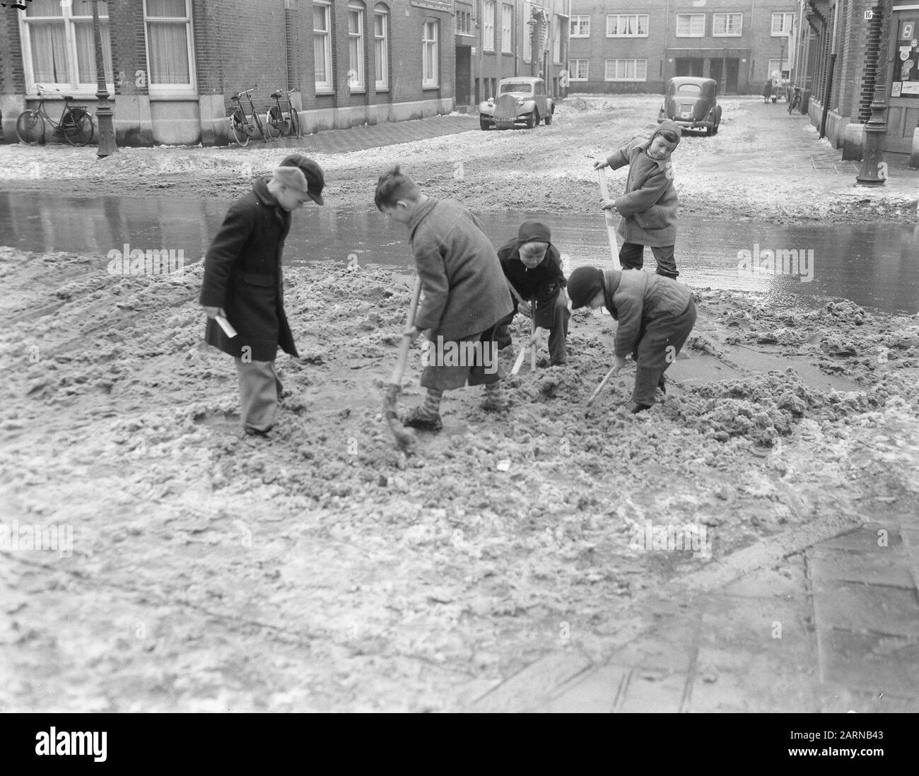 Children playing in snow thaw Date: 27 February 1956 Keywords: Children ...