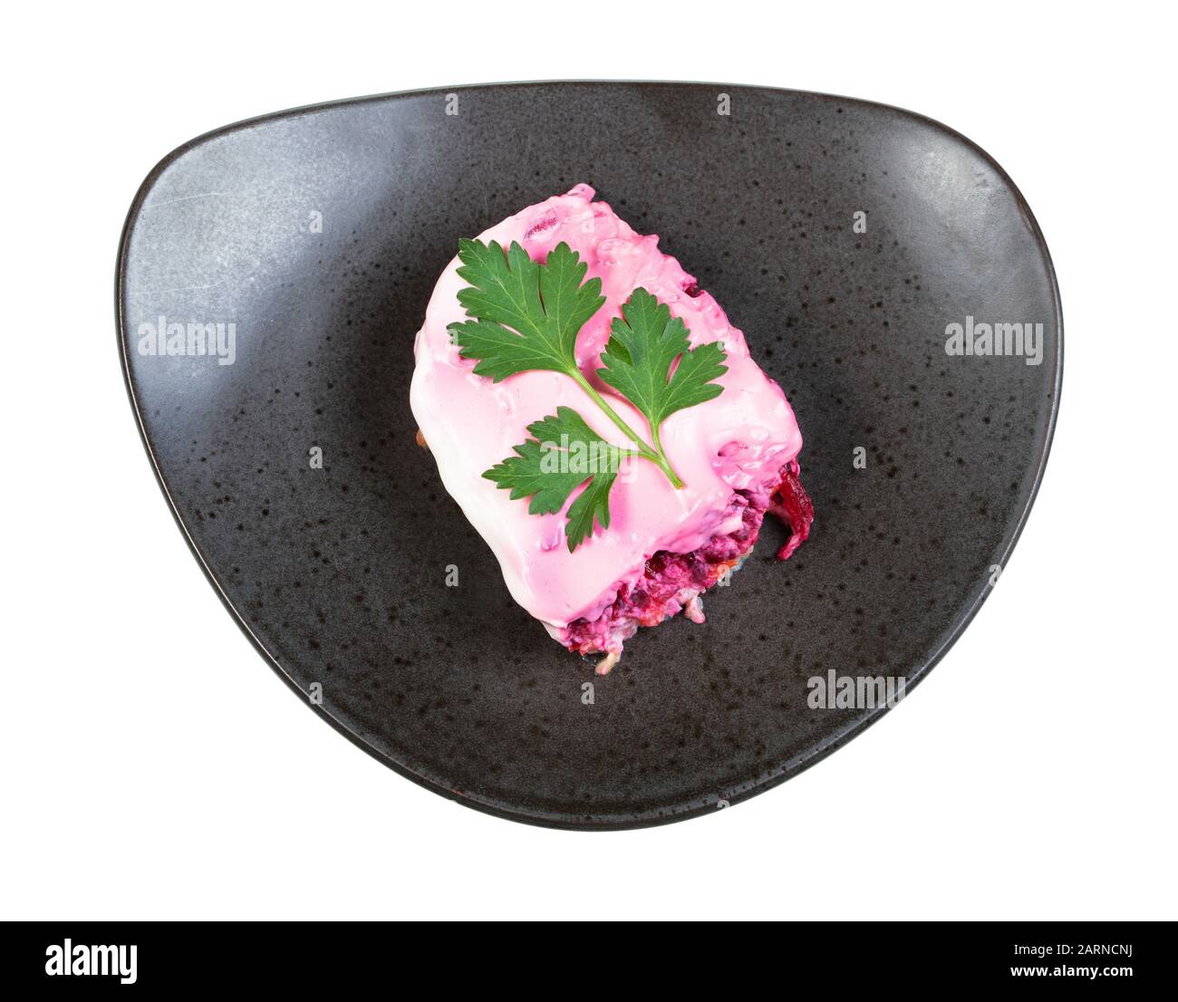 top view of portion of Dressed herring russian salad decorated by leaf ...
