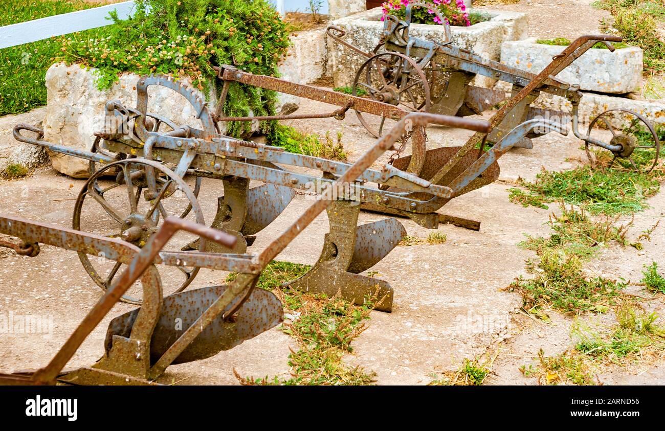 Ancient iron plows on a farm in the countryside of Puglia Stock Photo ...