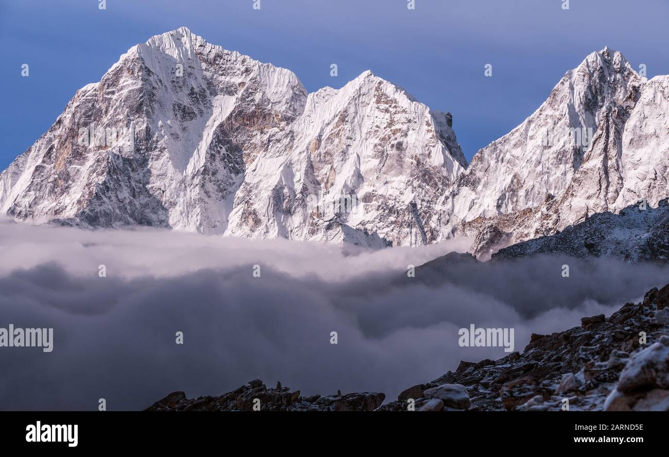 Majestic Himalayan peaks towering above the clouds at sunrise in Nepal ...
