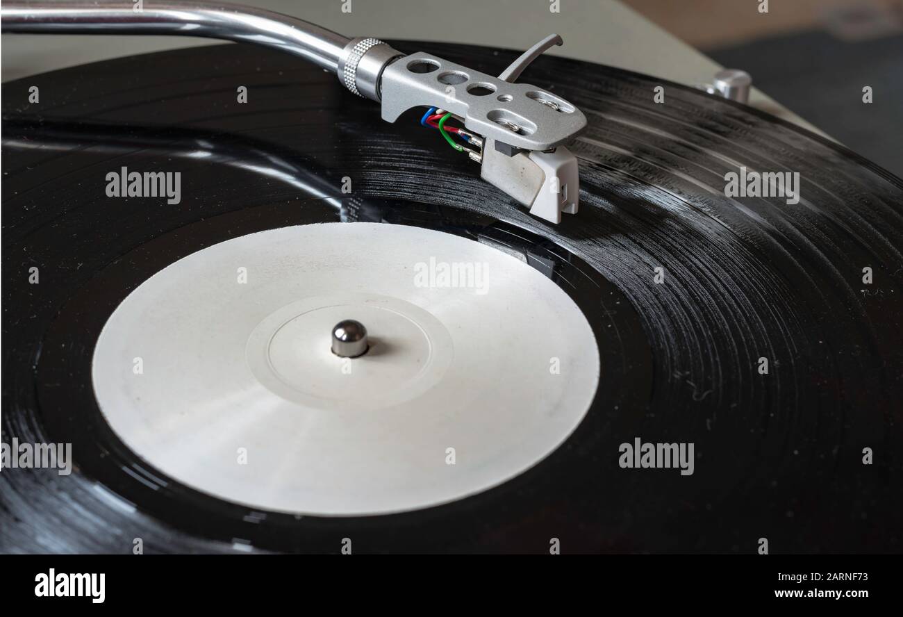 Closeup turntable player playing vinyl record disc. Focus on needle ...