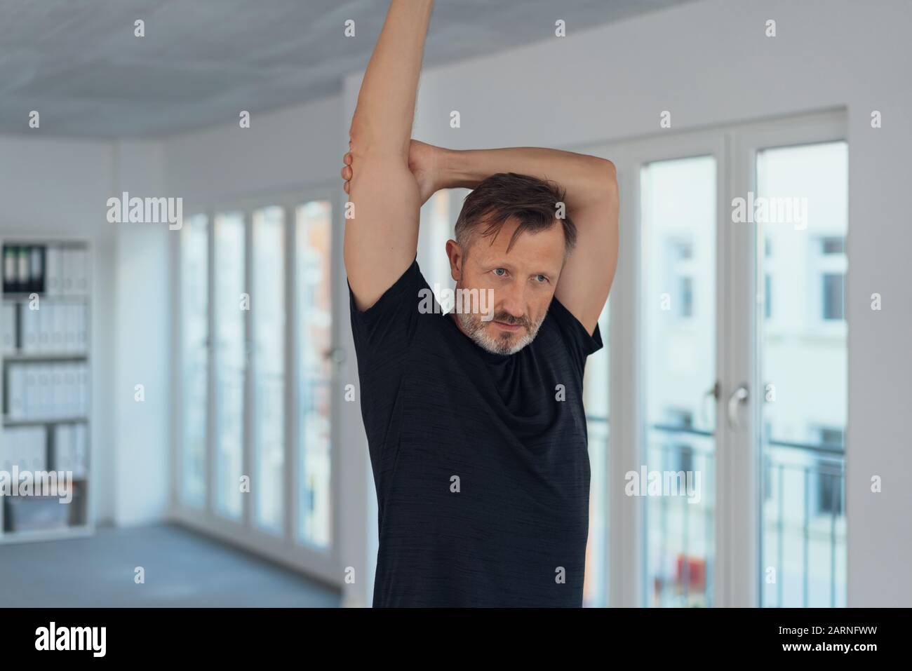 Man doing arm stretching exercises to warm up his muscles before ...