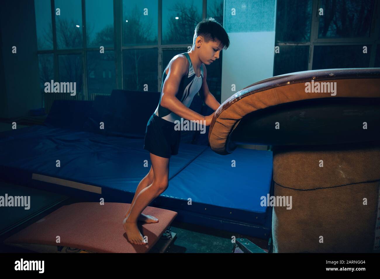 Little male gymnast training in gym, flexible and active. Caucasian fit ...