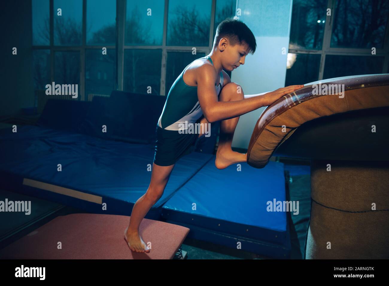 Little male gymnast training in gym, flexible and active. Caucasian fit ...