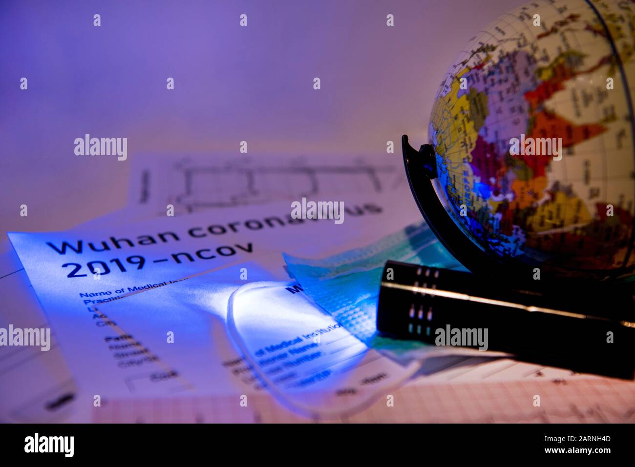 Medicine documents under ultraviolet light with small globe on it ...