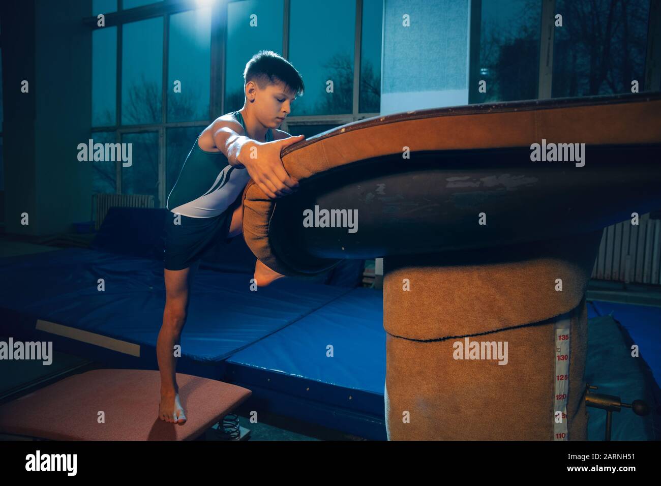 Little male gymnast training in gym, flexible and active. Caucasian fit ...
