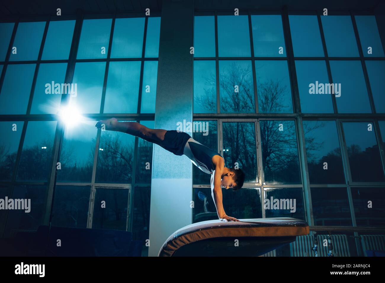 Little male gymnast training in gym, flexible and active. Caucasian fit ...