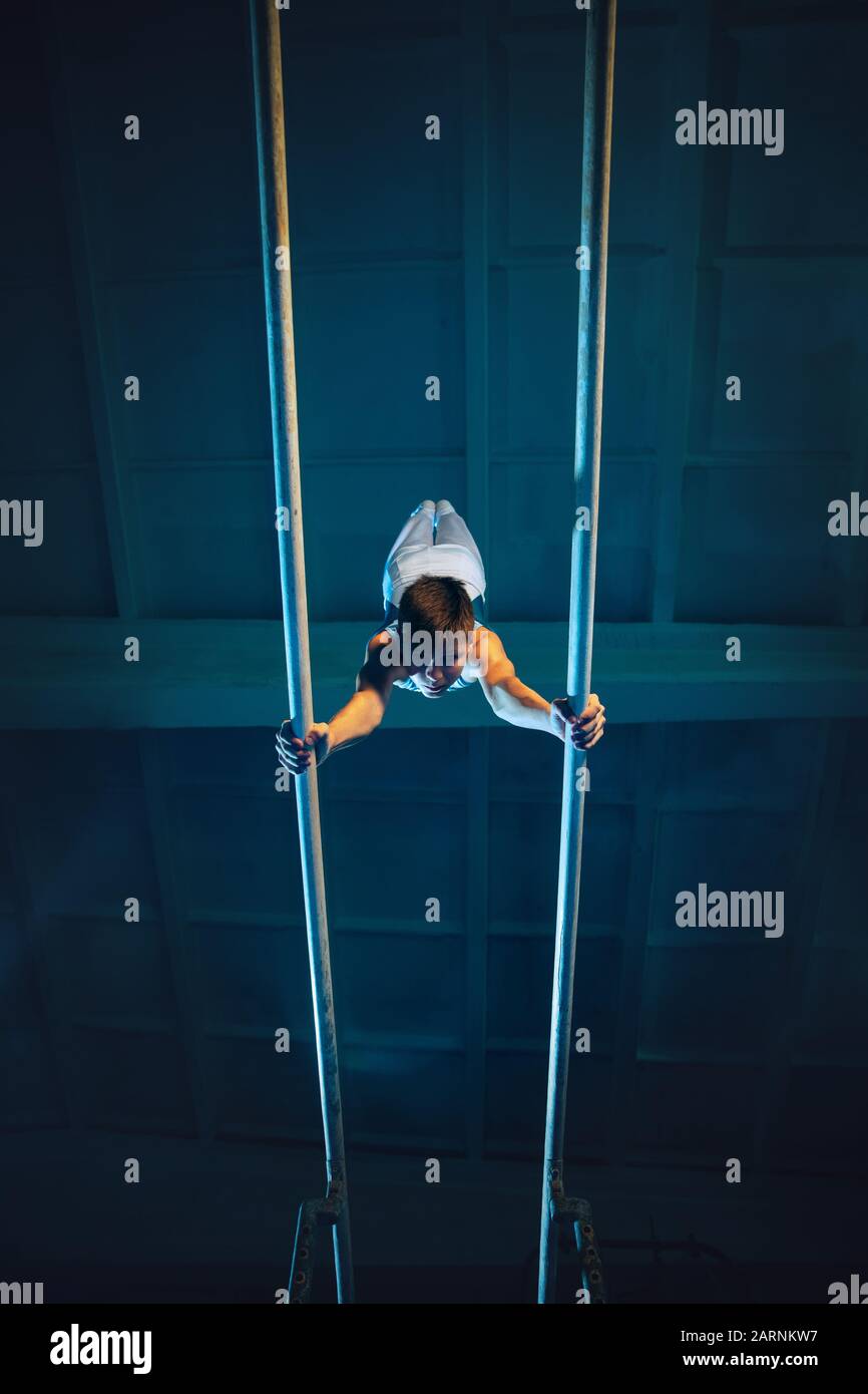 Little male gymnast training in gym, flexible and active. Caucasian fit ...