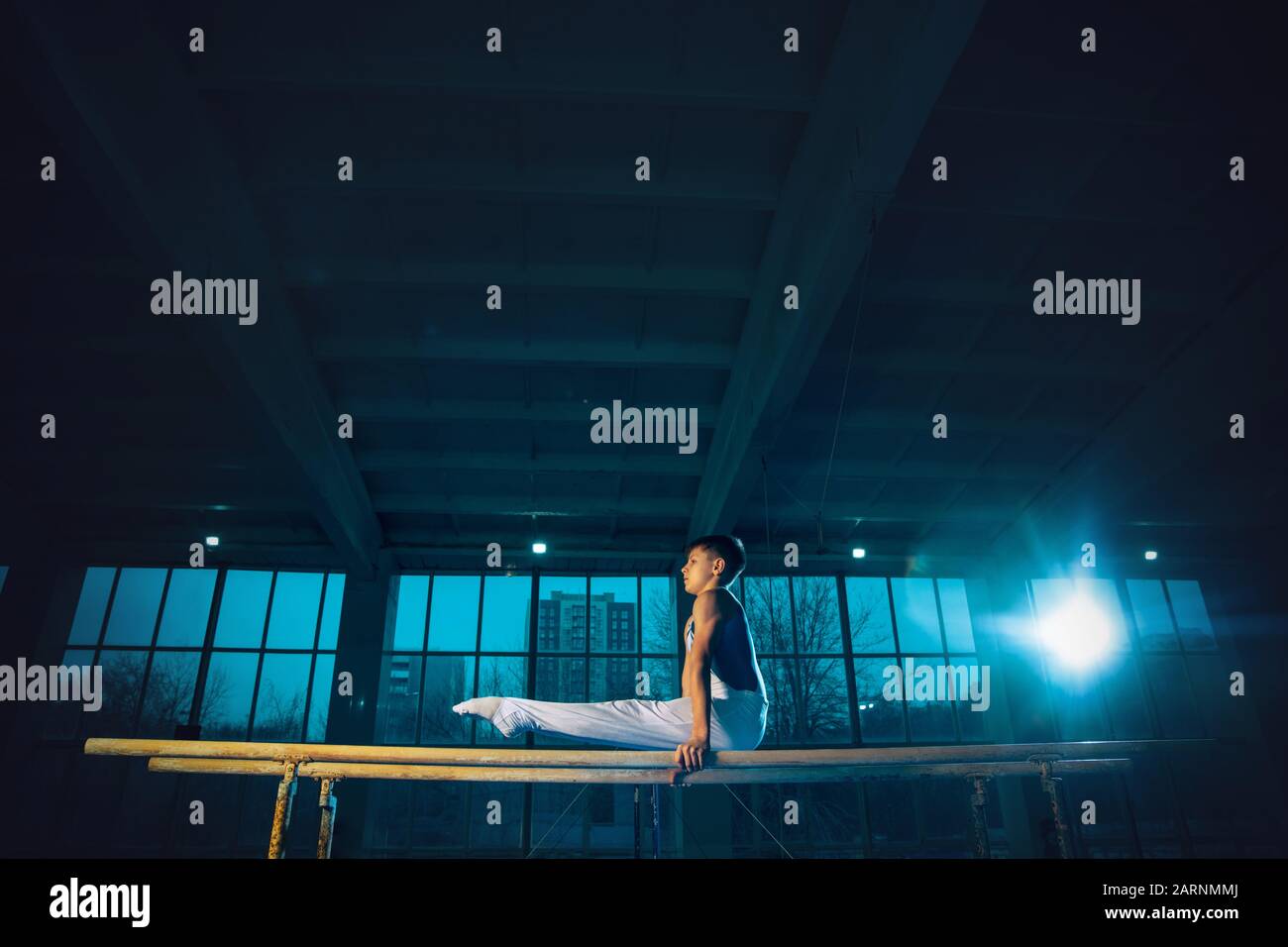 Little male gymnast training in gym, flexible and active. Caucasian fit ...