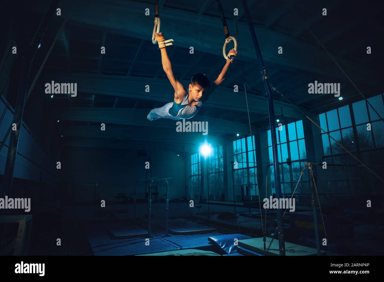 Little male gymnast training in gym, flexible and active. Caucasian fit ...