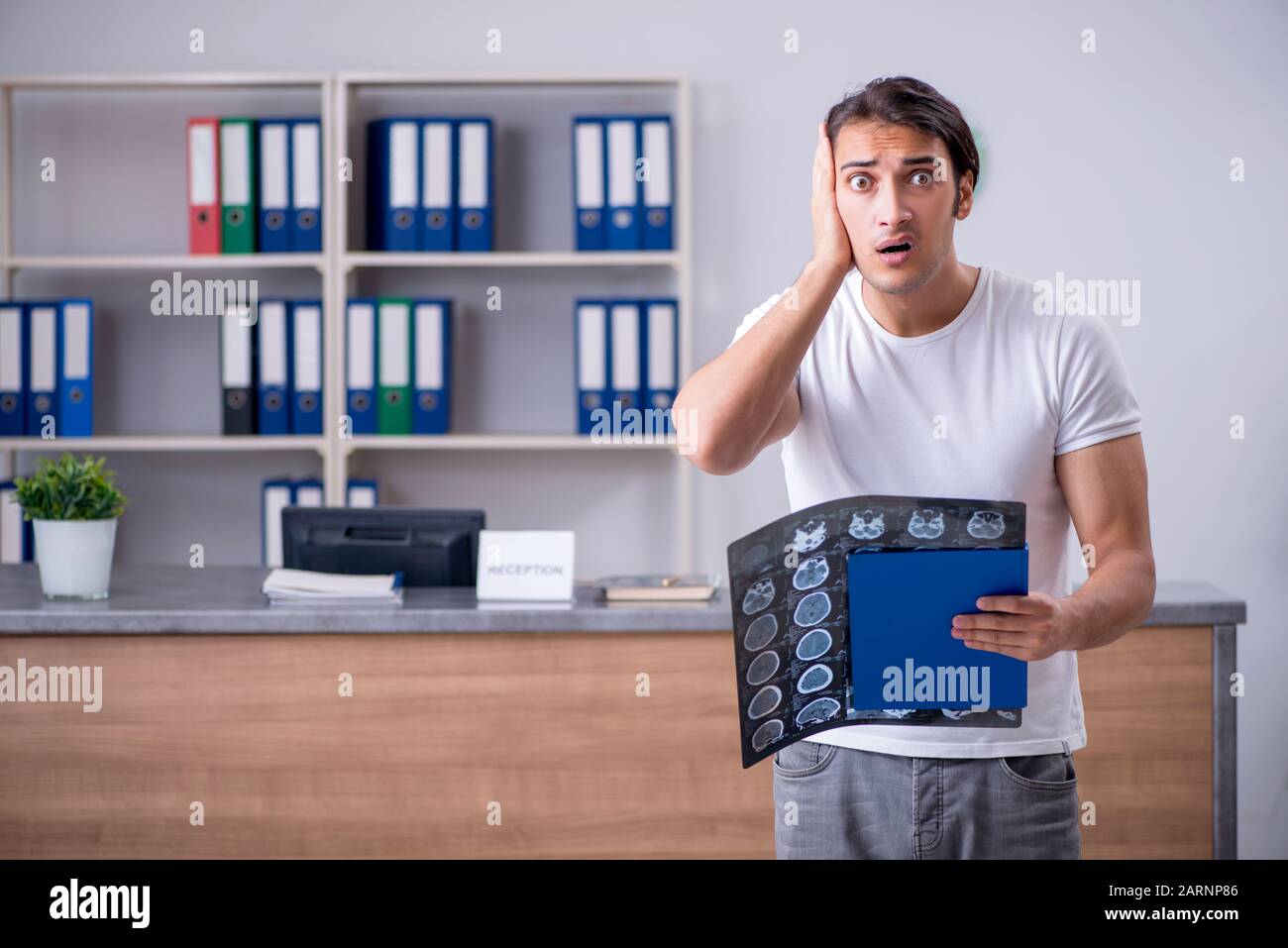 Clinic reception counter and young patient Stock Photo - Alamy