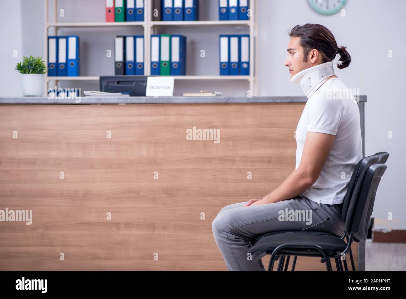 Clinic reception counter and young patient Stock Photo - Alamy