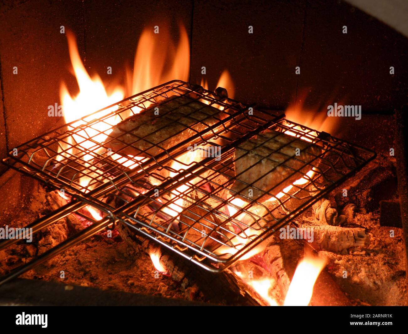 Fish fillets are grilled over an open fire Stock Photo - Alamy