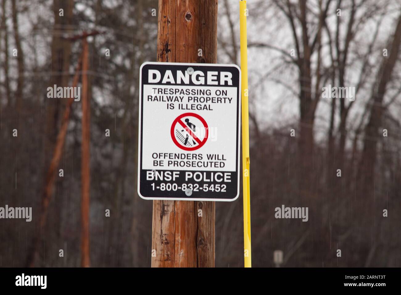 A BNSF no trespassing sign, by the tracks in the town of Troy, Montana ...