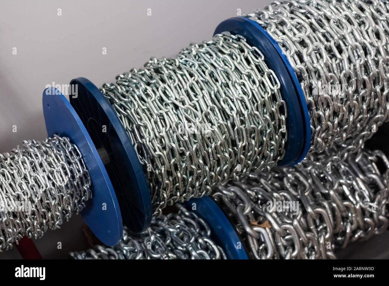 Large chain wound into a coil close up Stock Photo - Alamy
