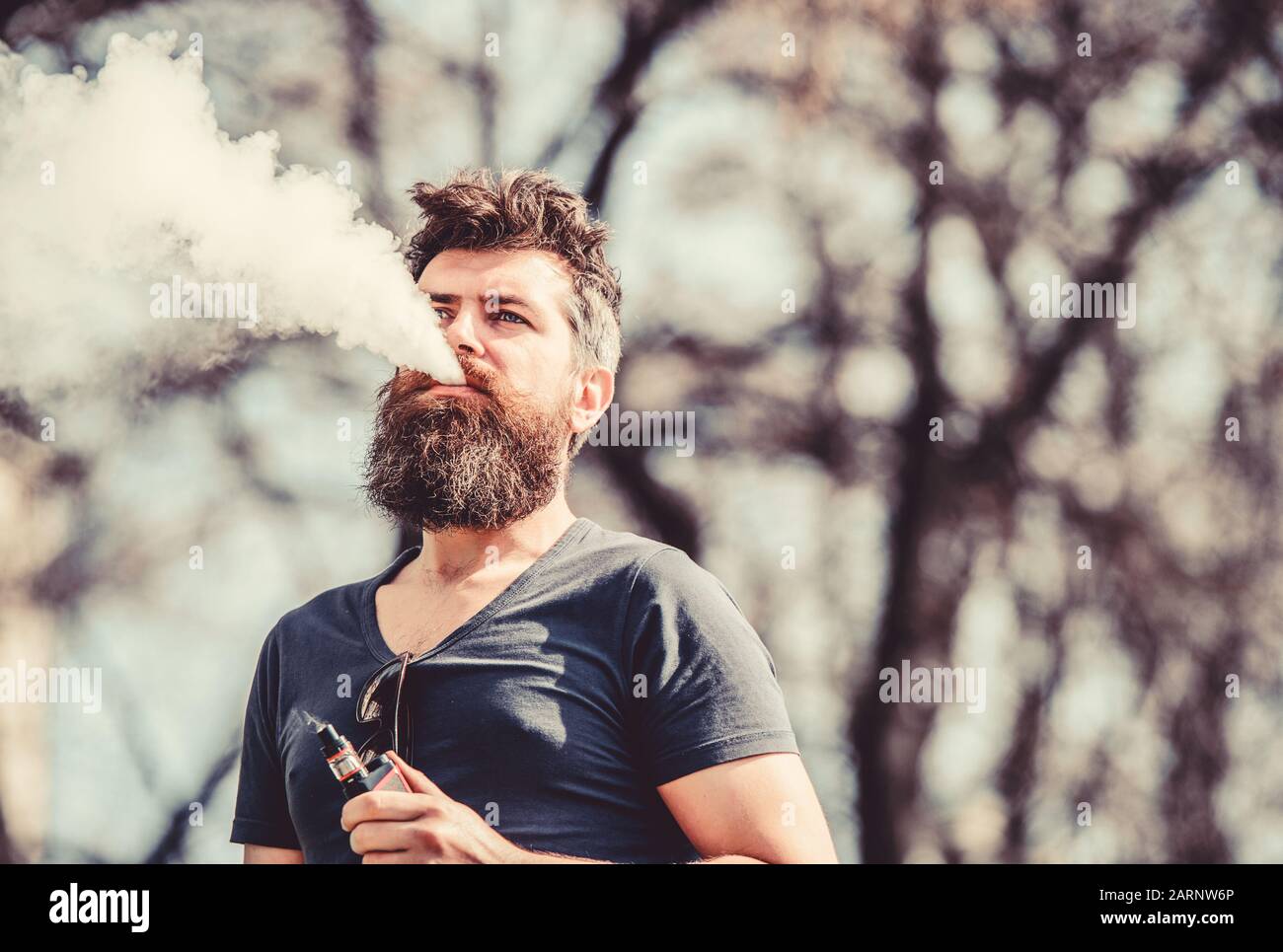 Stress relief concept. Bearded man smoking vape. Smoking electronic ...