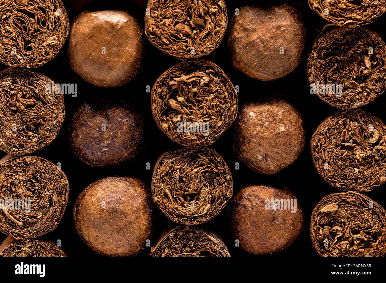 Cuban cigars: Hand rolled tobacco. Stacked cigars close up Stock Photo ...