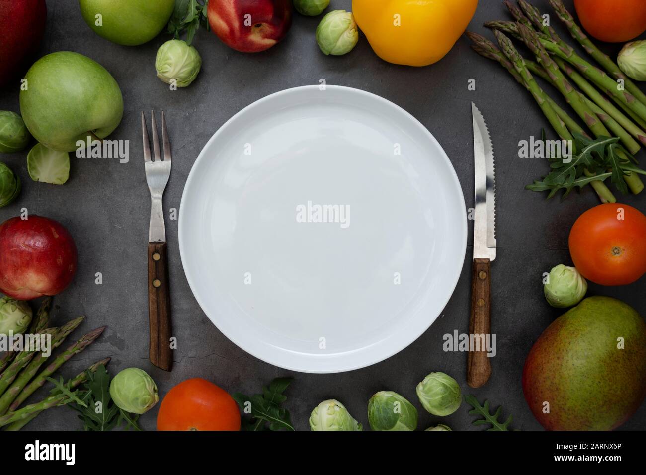 Healthy foods or diet concept. Empty round plate with different fruits ...