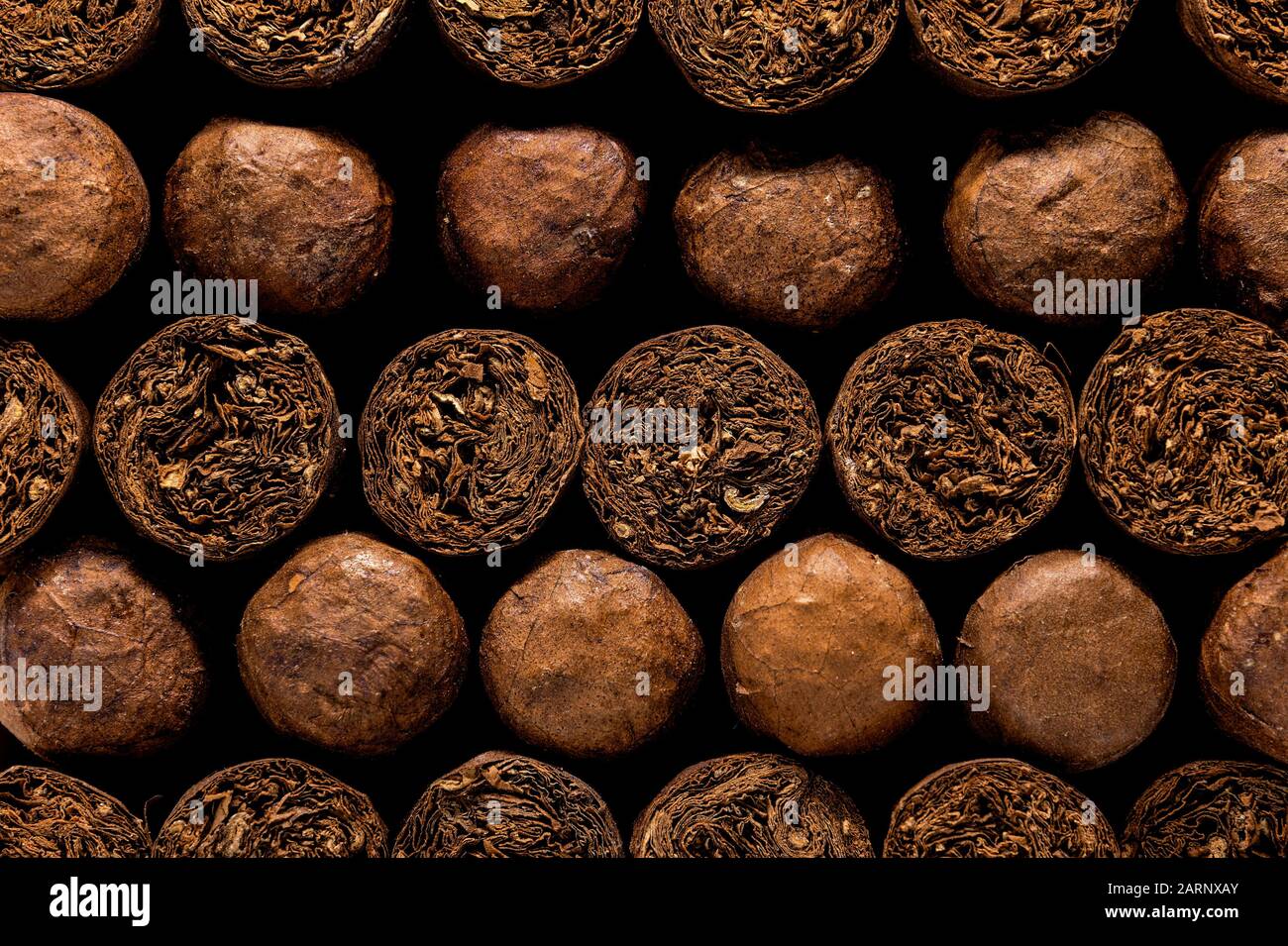 Cuban cigars: Hand rolled tobacco. Stacked cigars close up Stock Photo ...