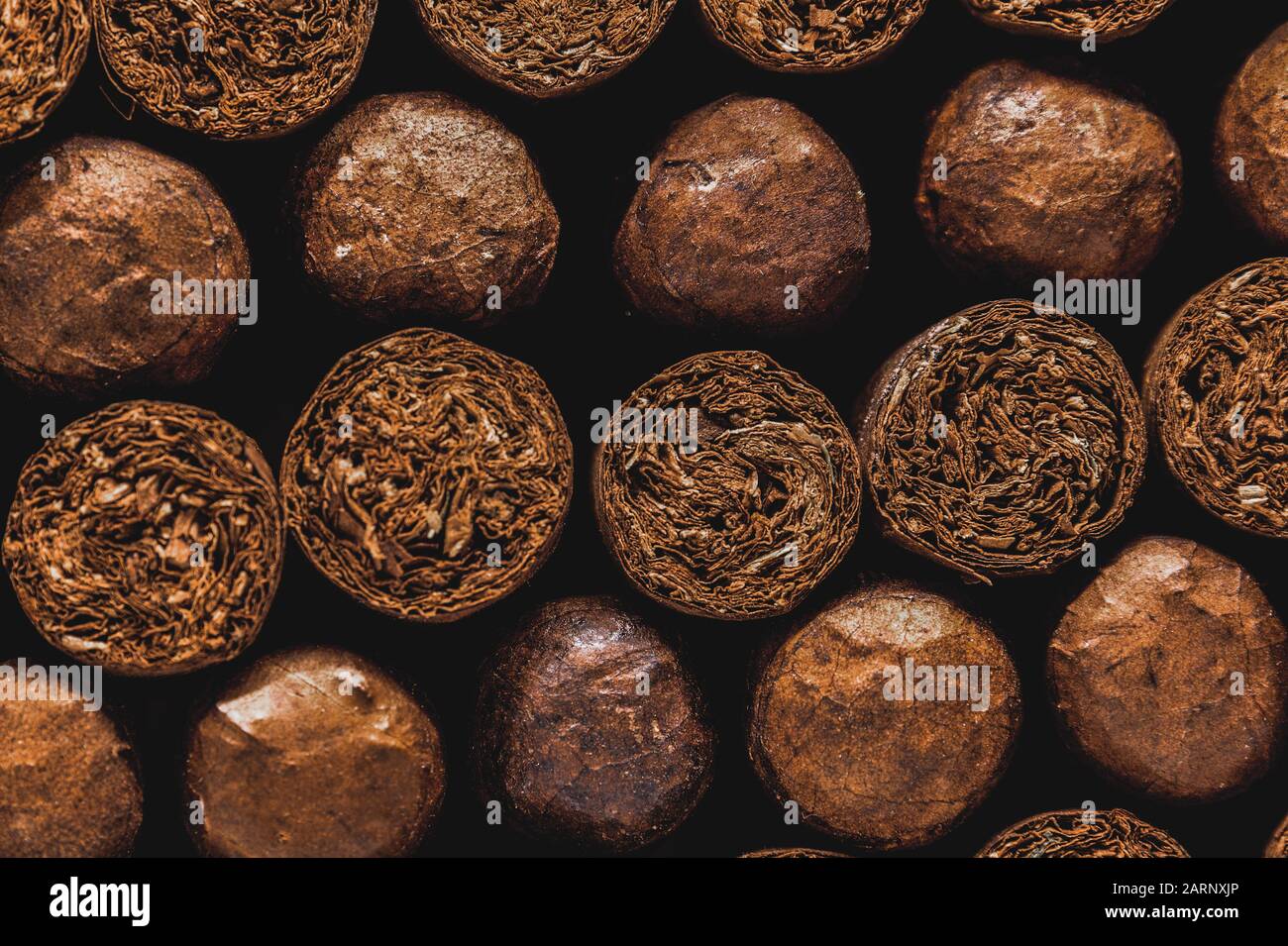 Cuban cigars: Hand rolled tobacco. Stacked cigars close up Stock Photo ...