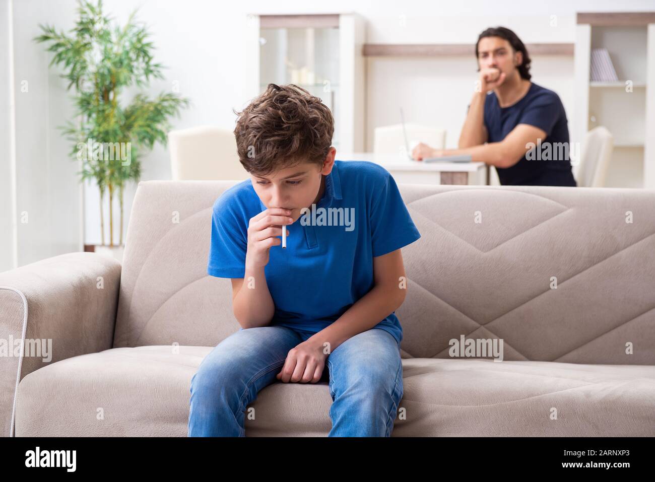 The concept of underage smoking with young boy and family Stock Photo ...