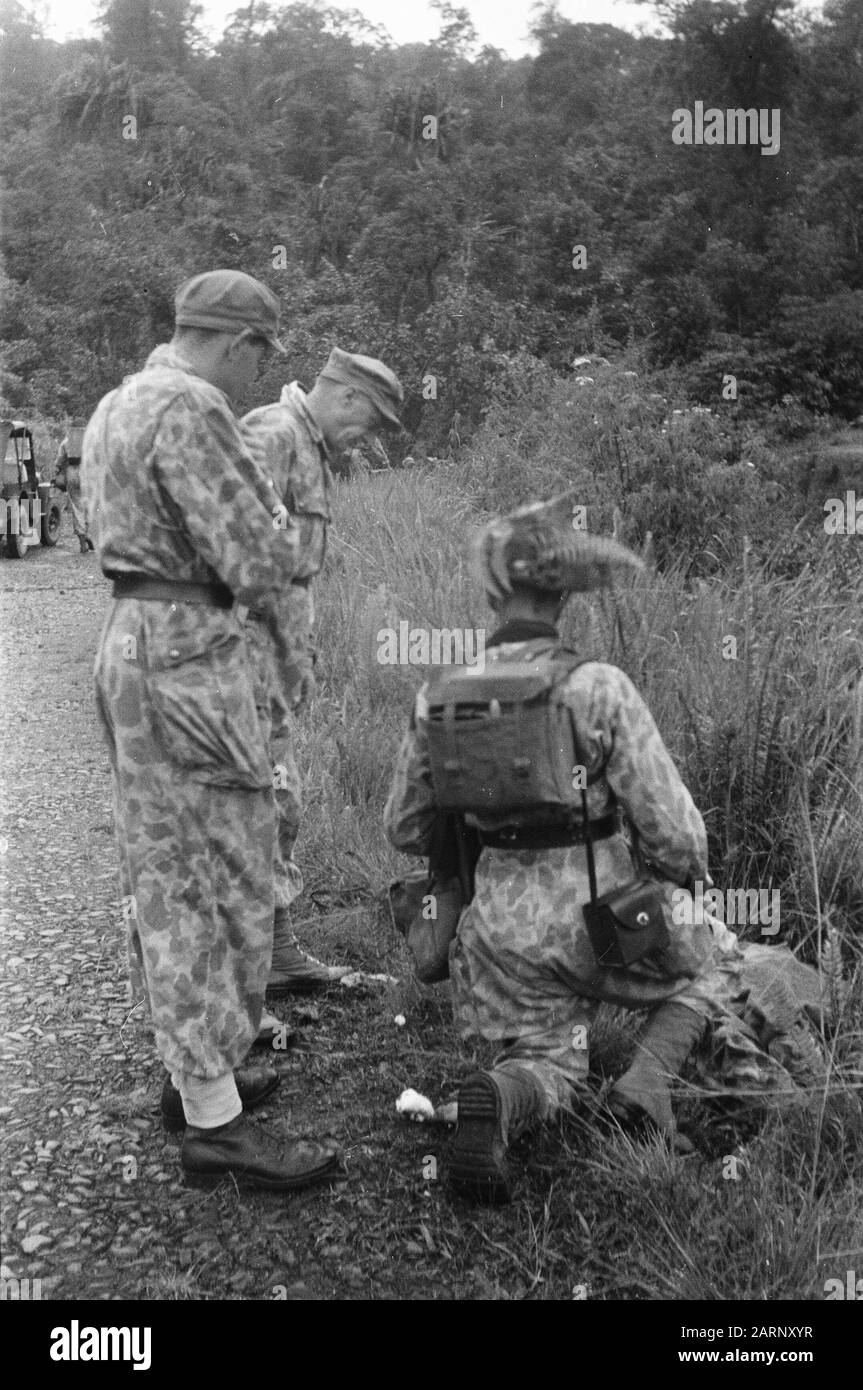 Advance from Padang [three Dutch soldiers in camouflage suits look at a ...