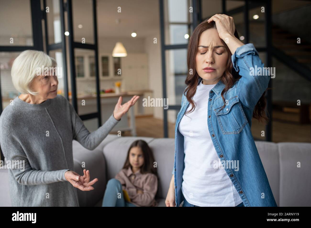 Adult daughter and mom argue while talking Stock Photo - Alamy