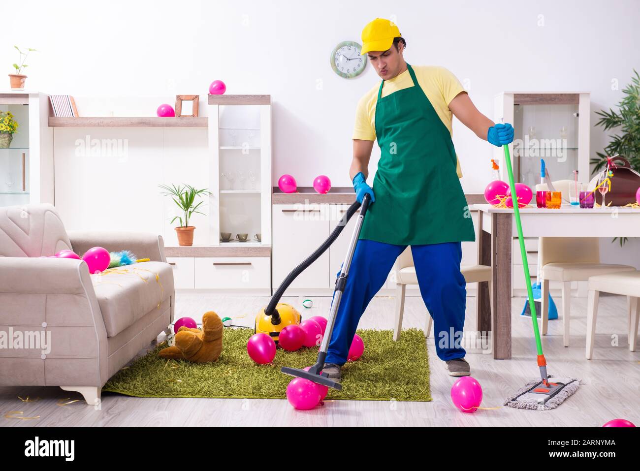 The young male contractor doing housework after party Stock Photo - Alamy