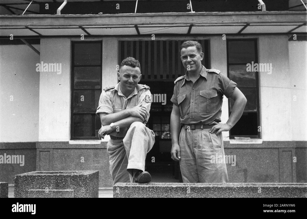 A major (left) and a captain posing in front of the entrance of a ...