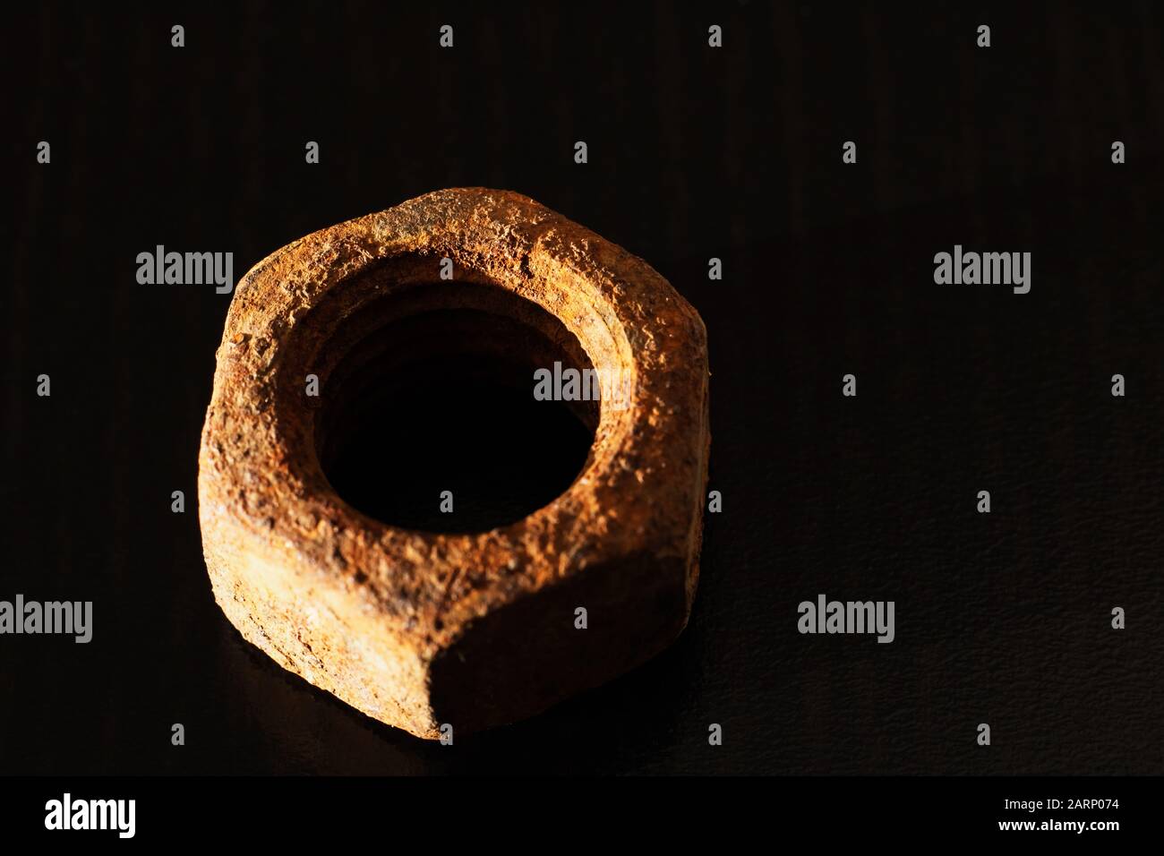 Large old rusty nut close up on black background Stock Photo - Alamy