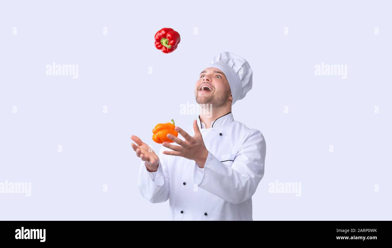 Excited Chef Man Juggling Sweet Peppers Standing In Studio, Panorama ...