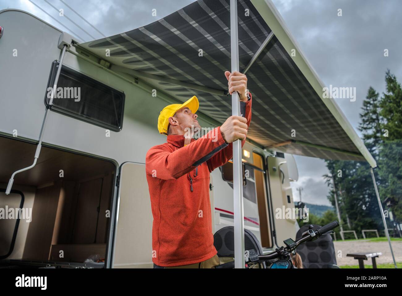 RV Motorhome Awning Extending by Caucasian Camper in His 30s. Travel ...