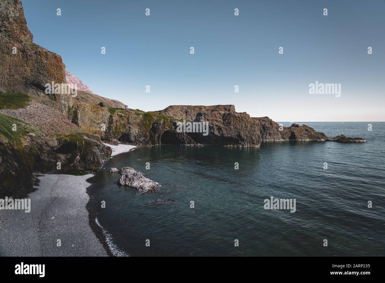 Arctic Beach with small waterfall in Greenland. Near small village of ...