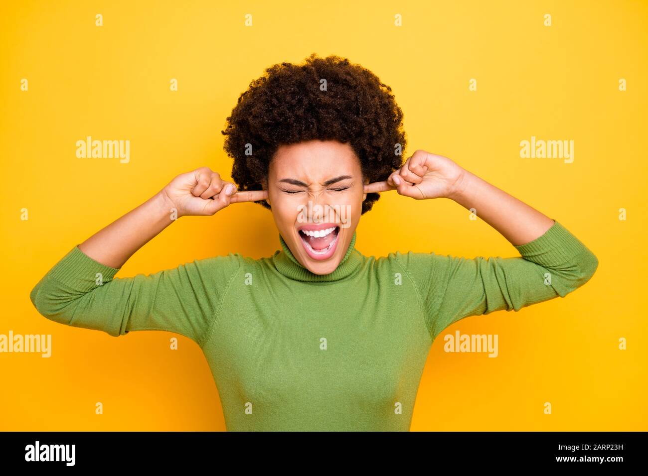 Photo of screaming shouting grimacing girl shutting ears not to hear ...