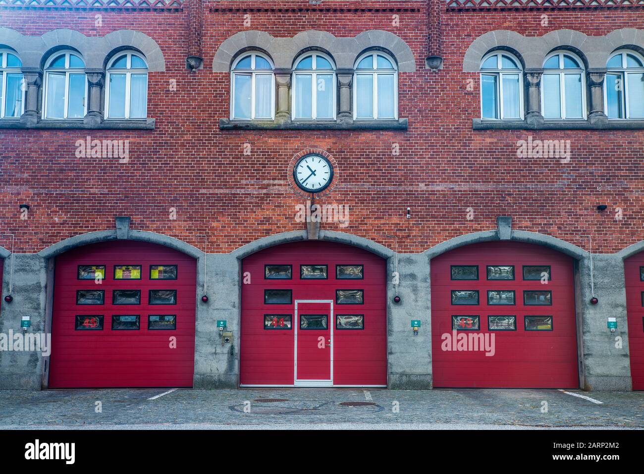 Facade of an old classic fire station with red doors in Malmo, Sweden ...
